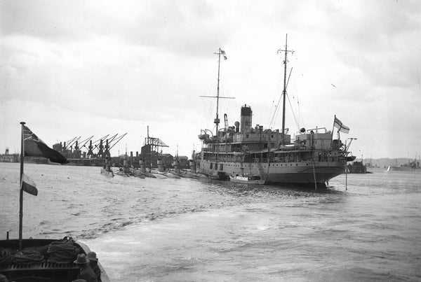 HMS 'Titania' (1915) submarine depot ship, moored at Portland with 6 ...